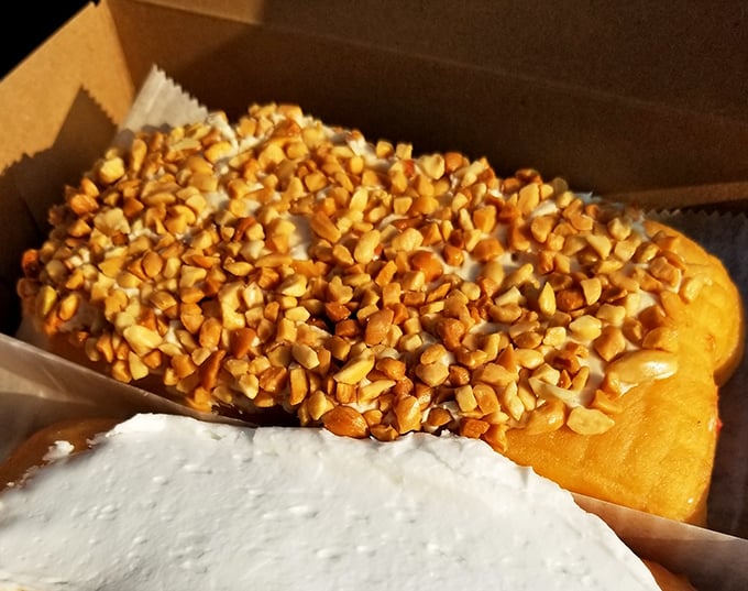 A peanut butter long john that doesn't just sit on the plate&mdash;it commands attention with its generous nutty crown.