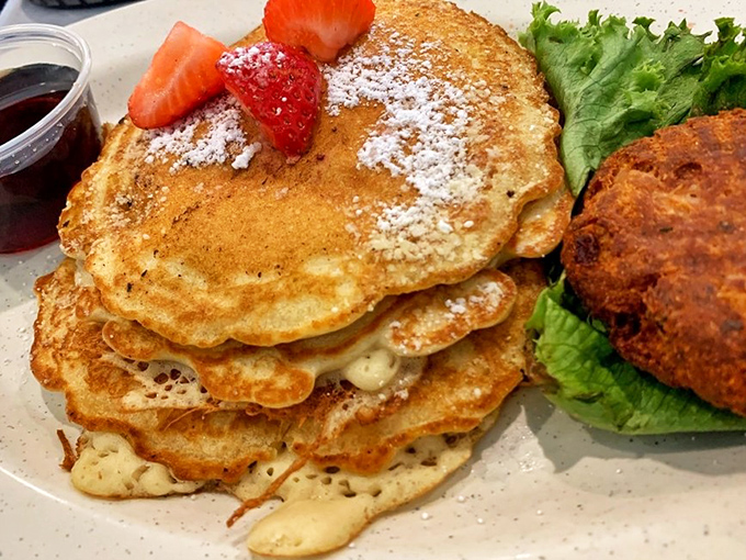 Pancakes stacked higher than my expectations, yet somehow exceeding them. That strawberry on top isn't garnish—it's the crown jewel.