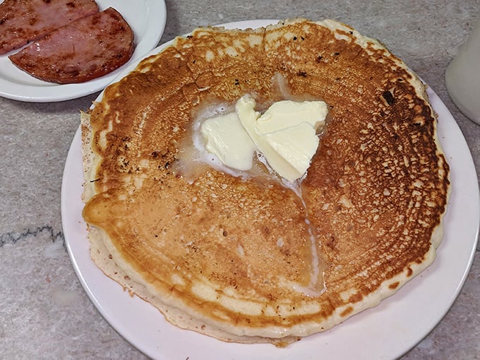 Pancakes the size of hubcaps, golden as a summer sunset, with butter melting into sweet submission.