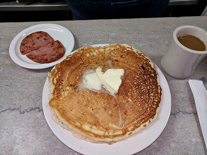 Golden pancakes arrive like edible sunshine, ready to soak up syrup and deliver the kind of morning joy that lasts.