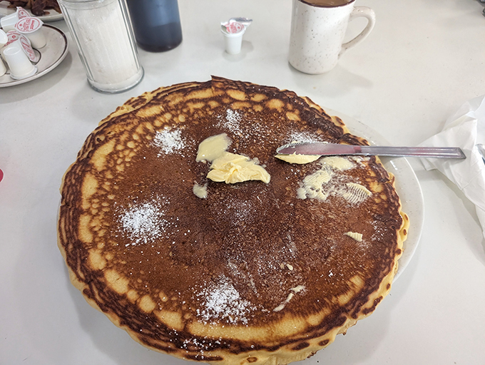 This pancake isn't just breakfast – it's an edible frisbee of joy, waiting for butter to perform its melting magic act.