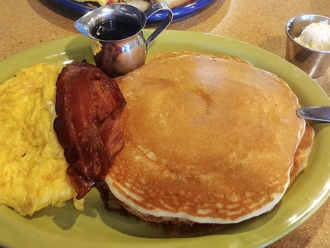 Pancakes so perfectly golden they could make a maple tree weep with joy, served with eggs and bacon for the breakfast trifecta.