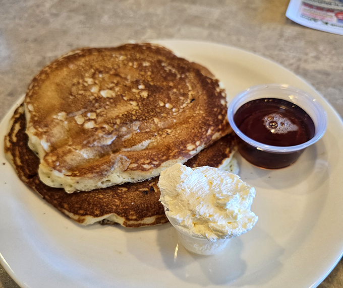 Pancakes so perfectly golden they belong in Fort Knox. That whipped butter melting into those fluffy discs is nature's most beautiful slow-motion sequence.