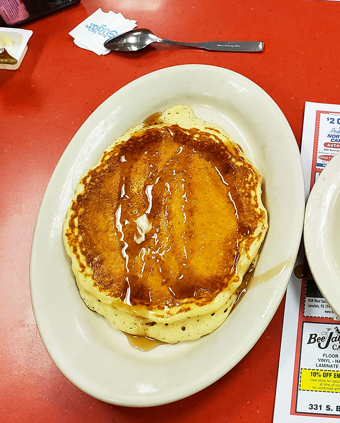A pancake so perfectly golden it could win a beauty pageant. The syrup river running across its surface is nature's most perfect waterway.