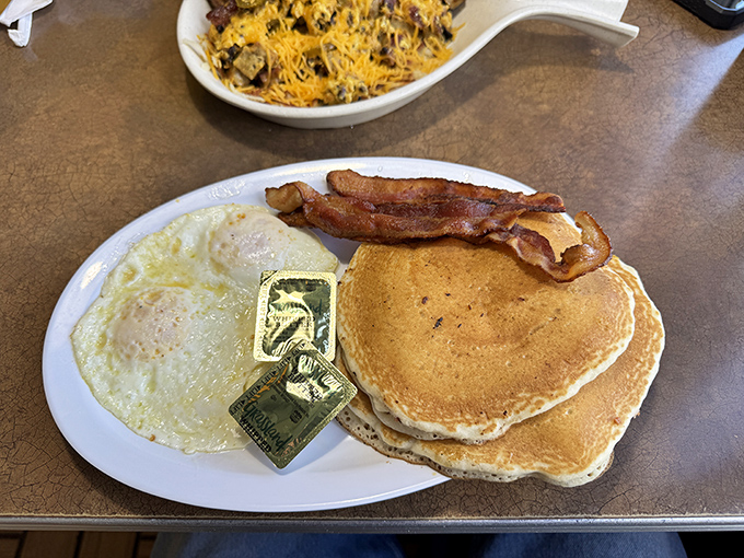 Golden pancakes with the perfect tan lines, eggs sunny-side up, and bacon that's achieved crispy perfection. The breakfast trifecta has been achieved.