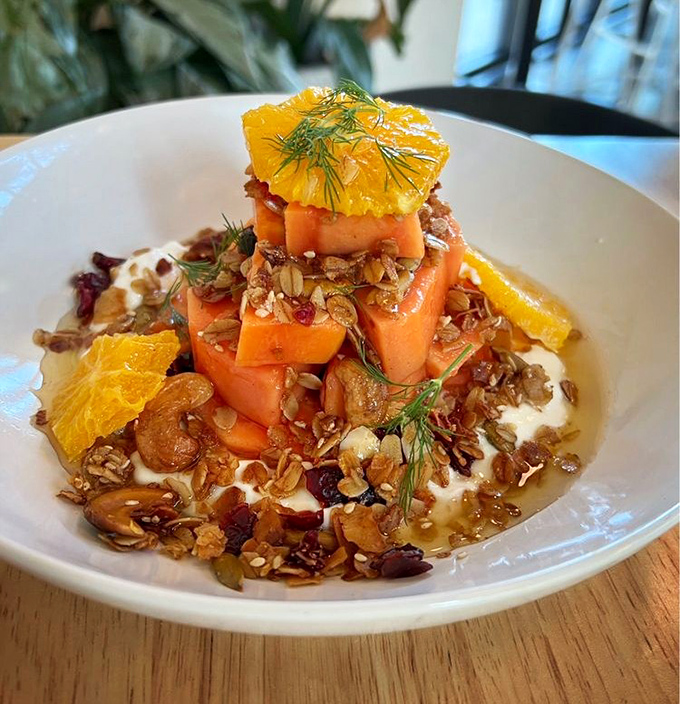 Papaya, yogurt, and housemade granola stacked like a tropical Jenga tower. Breakfast that's both Instagram-worthy and genuinely satisfying.