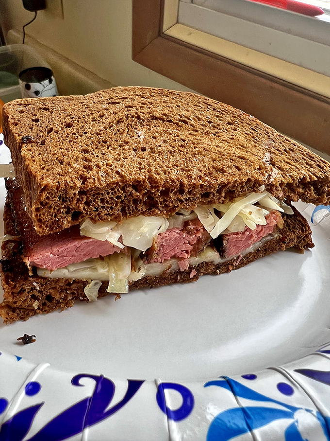 This Reuben isn't just a sandwich, it's architecture &ndash; layers of house-smoked pastrami, tangy sauerkraut, and melty cheese creating the Taj Mahal of lunch options.