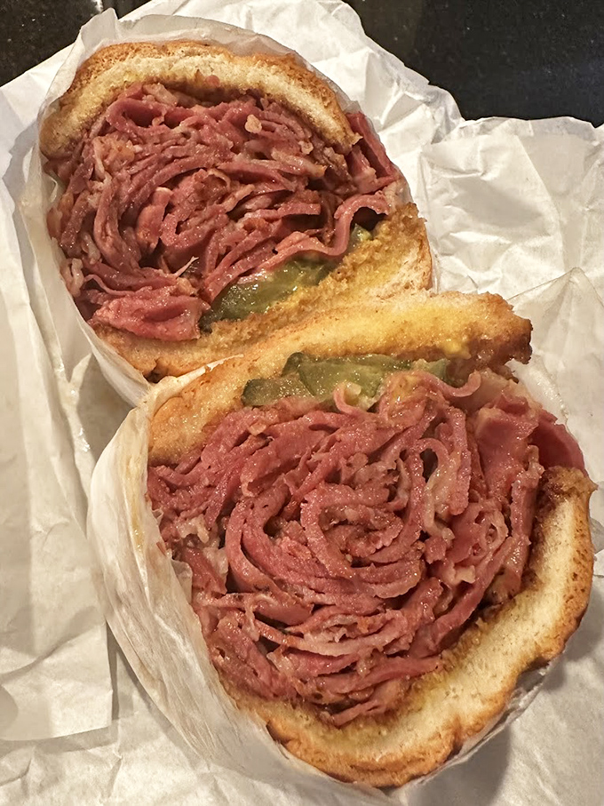The pastrami sandwich that launched a thousand cravings. Pink, peppery meat piled high enough to make your jaw stretch in anticipation.