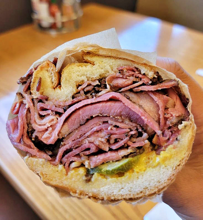 This towering pastrami sandwich defies gravity and common sense in the most delicious way possible.