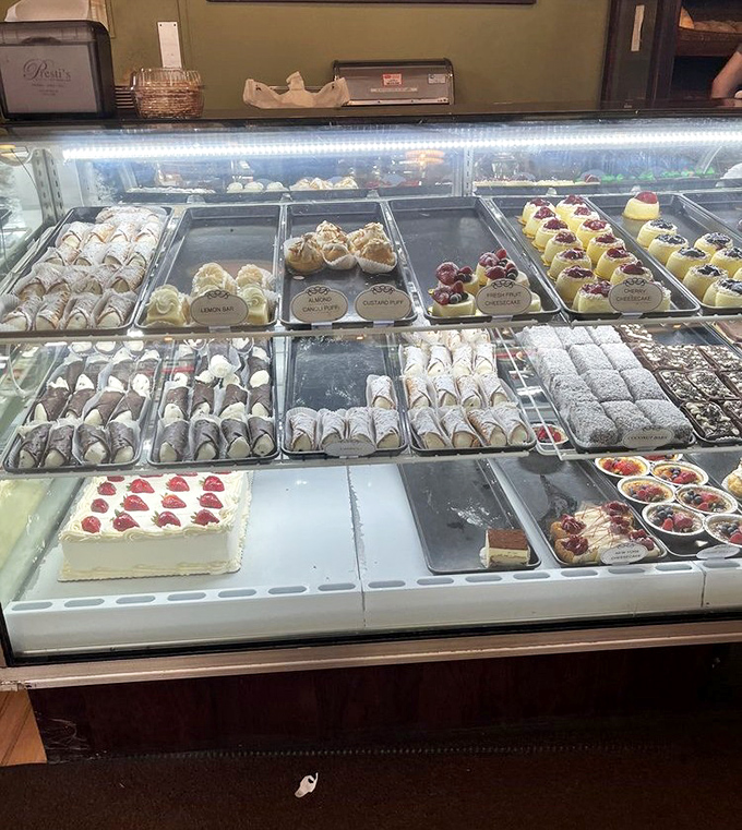 The display case &ndash; where dreams and diets go to negotiate terms. Each perfectly arranged pastry is a small masterpiece waiting for its moment.