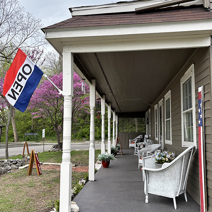 Front porch philosophy at its finest. White wicker chairs await beneath a welcoming veranda, where conversations flow as easily as the Mississippi.