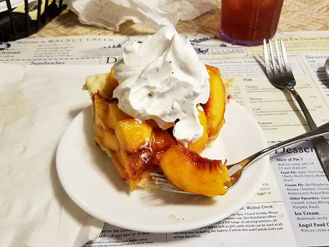 Fork meets peach pie in a moment of pure dessert bliss&mdash;the whipped cream merely a supporting actor to the star fruit beneath.