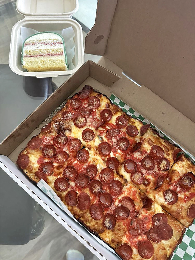 The pepperoni pizza comes in its own cardboard throne, with crispy-edged cheese and pepperoni cups that collect flavor like tiny savory chalices.