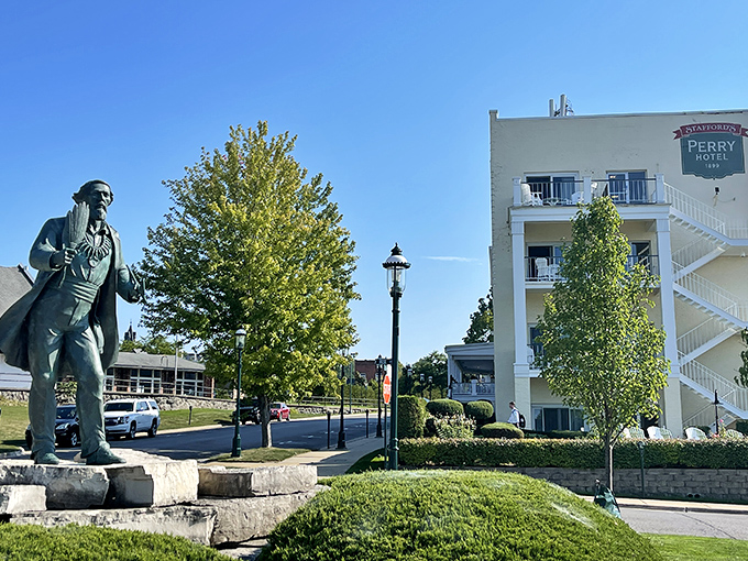 The historic Perry Hotel stands sentinel over Petoskey, while a bronze figure reminds visitors of the town's rich heritage.