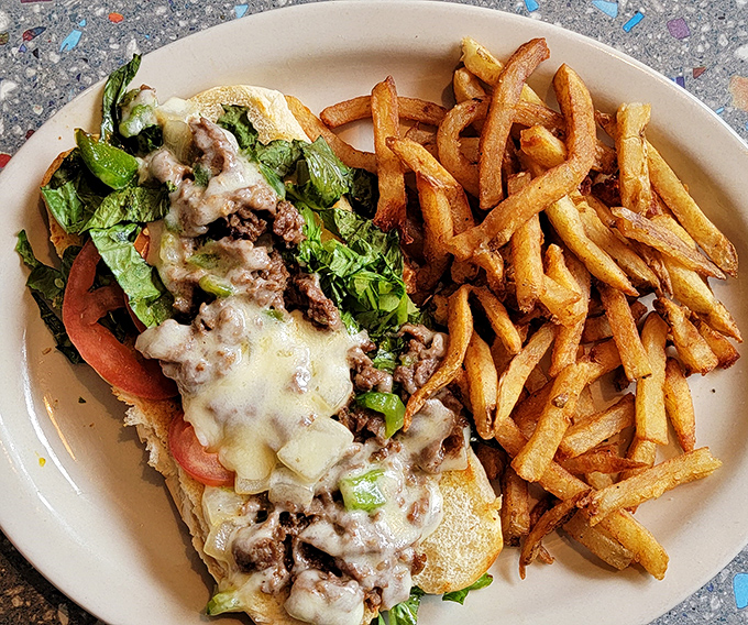 The legendary Philly cheesesteak in all its glory&mdash;tender beef, melted cheese, and fresh veggies served alongside golden fries that demand to be stolen. 