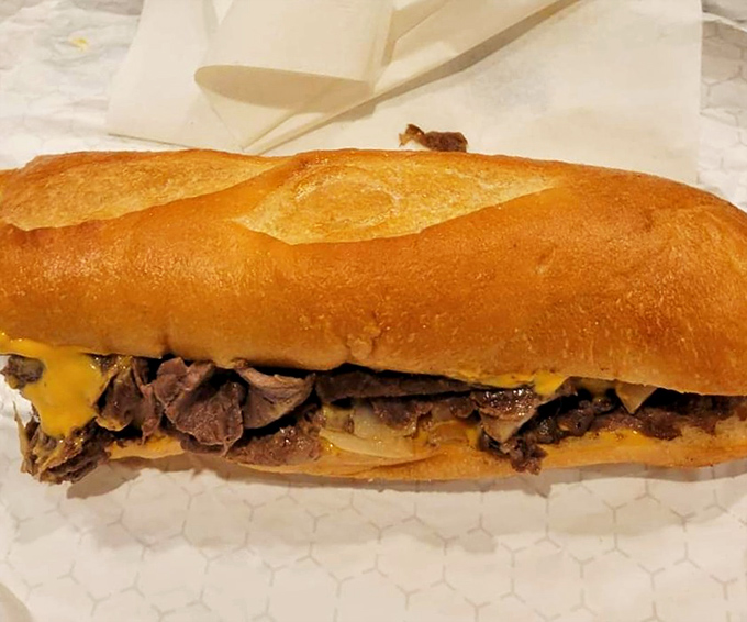 The classic beef cheesesteak&mdash;a Philadelphia handshake in edible form. Notice how the roll cradles the meat like it was born for this purpose.
