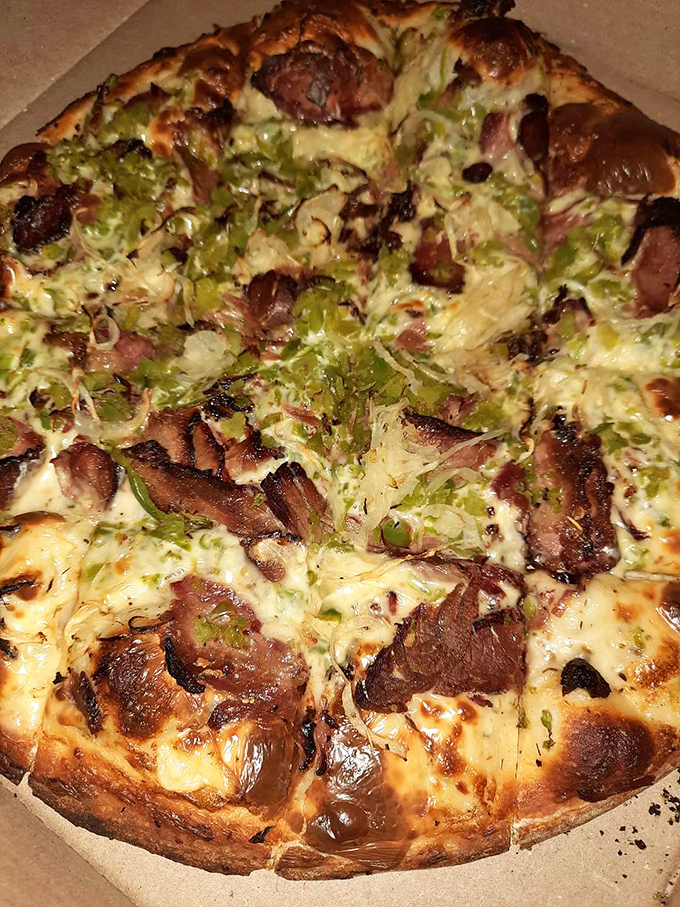 This isn't just a pizza—it's a carefully orchestrated symphony of meat, cheese, and green peppers that makes you forget all other food groups.