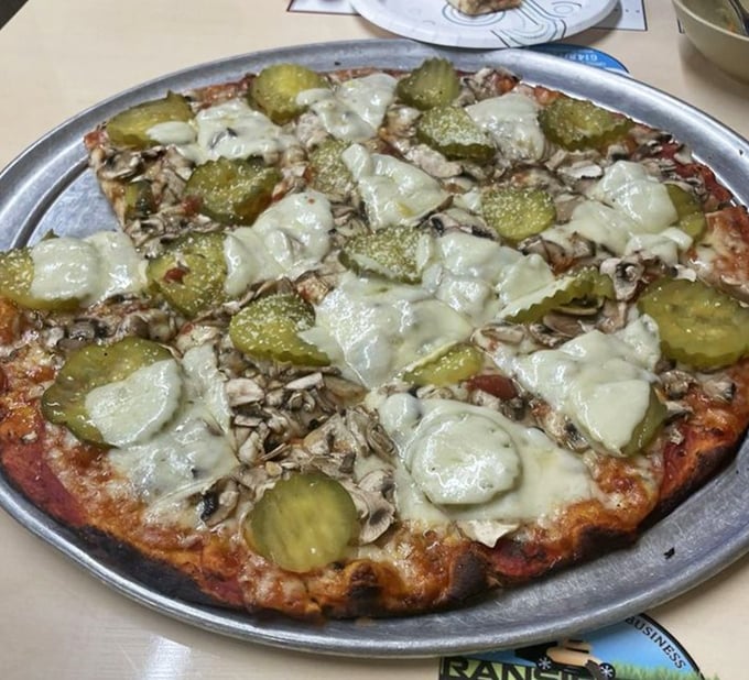 The pickle pizza might raise eyebrows among purists, but those tangy circles nestled among mushrooms create a flavor combination that's surprisingly addictive.