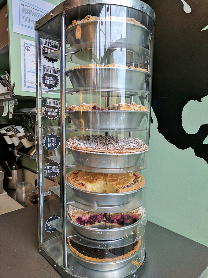 The pie tower of power! This glass case displays a rotating gallery of edible art where every shelf tells a different delicious story.
