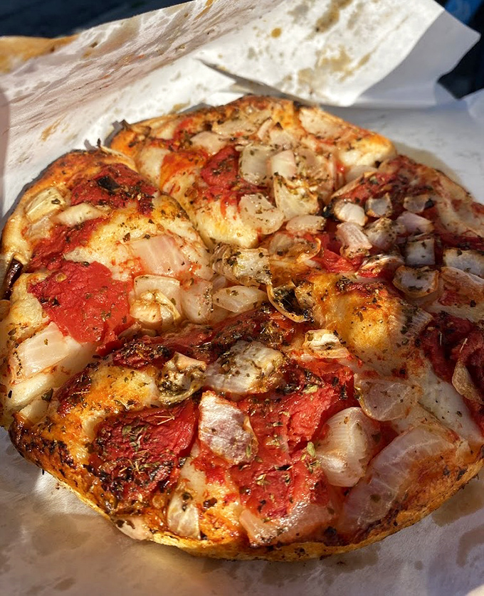 Pizza that refuses to follow trends. The thick, focaccia-like crust supports a simple harmony of sauce, cheese, and toppings without pretension.