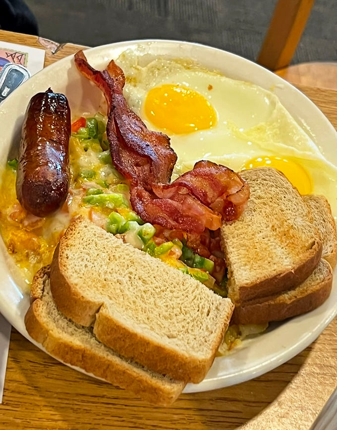 The breakfast of champions&mdash;eggs, sausage, bacon, and toast arranged like a painter's palette of morning delights.