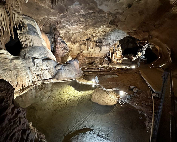 Crystal-clear pools reflect the ceiling formations with mirror-like precision. The water is so still you might question which way is up.