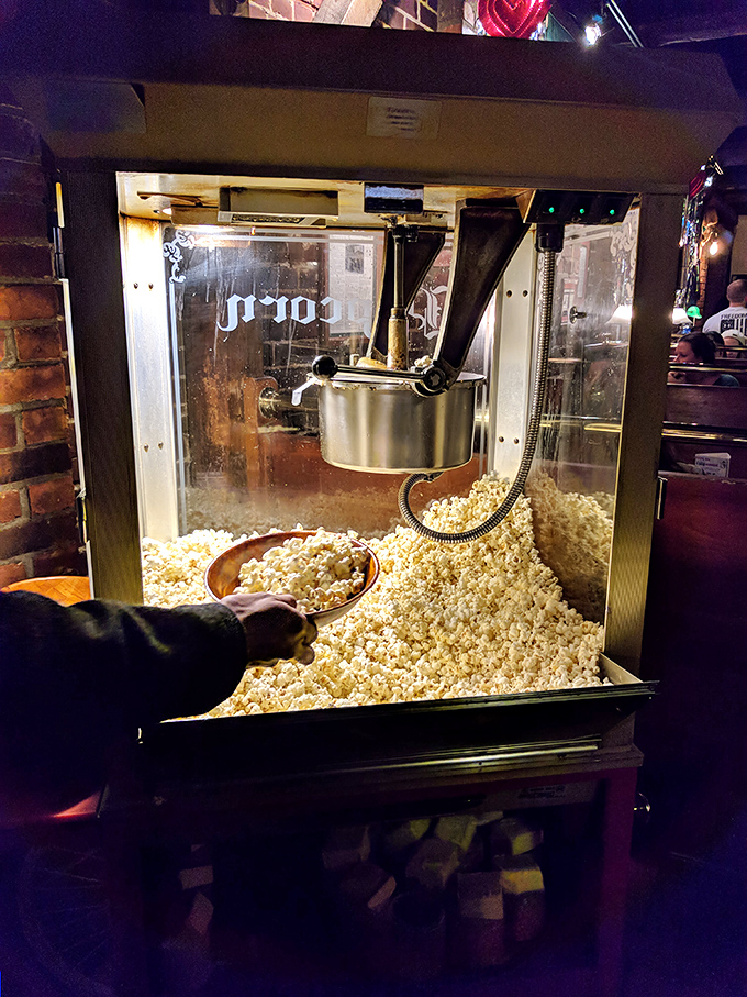 Fresh popcorn being scooped from an old-school machine &ndash; because sometimes the simplest pleasures make the perfect bar companion.