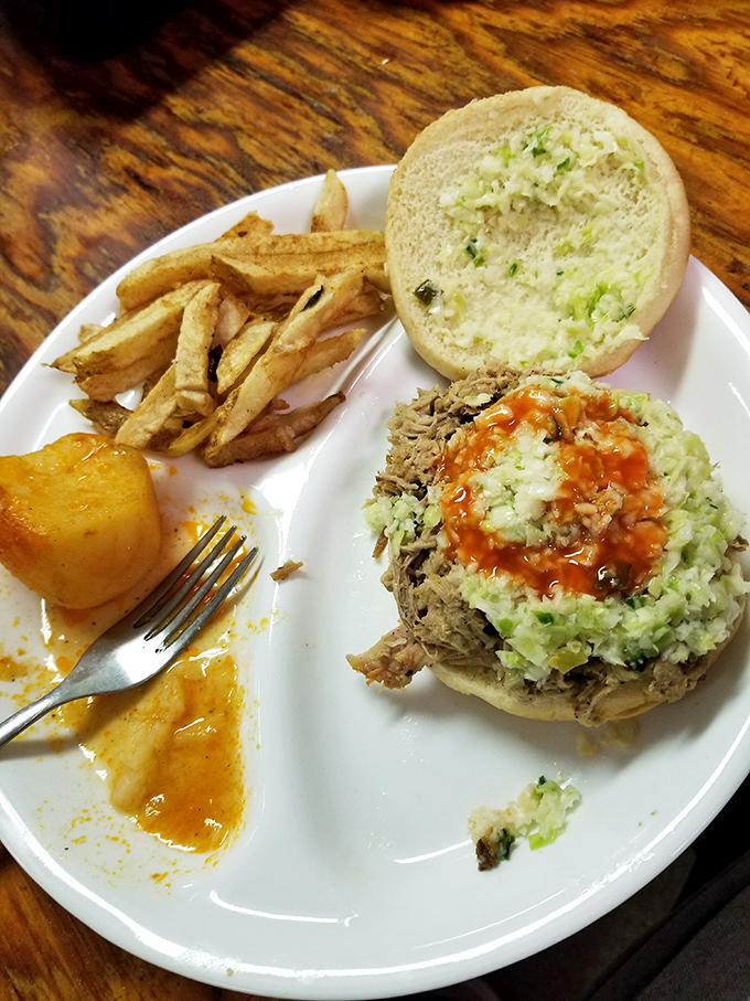 The BBQ sandwich comes dressed with slaw and sauce, a handheld masterpiece that's been perfected over countless lunch rushes.