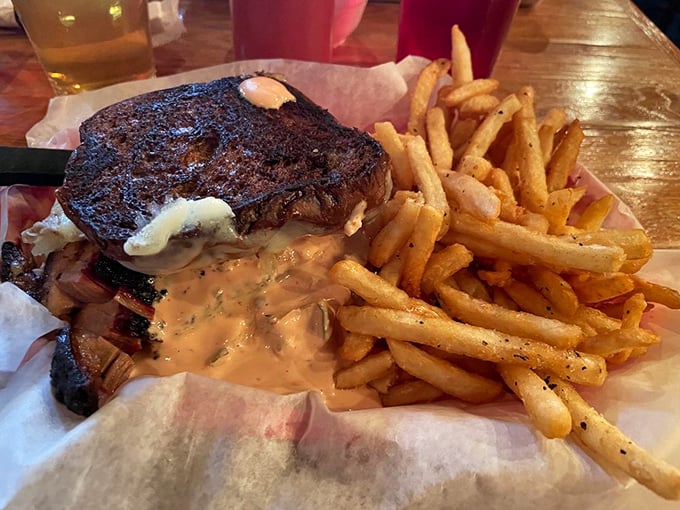 This isn't just a sandwich, it's architecture. Layers of smoky meat, melty cheese, and sauce create a skyscraper of flavor that demands both hands and extra napkins.