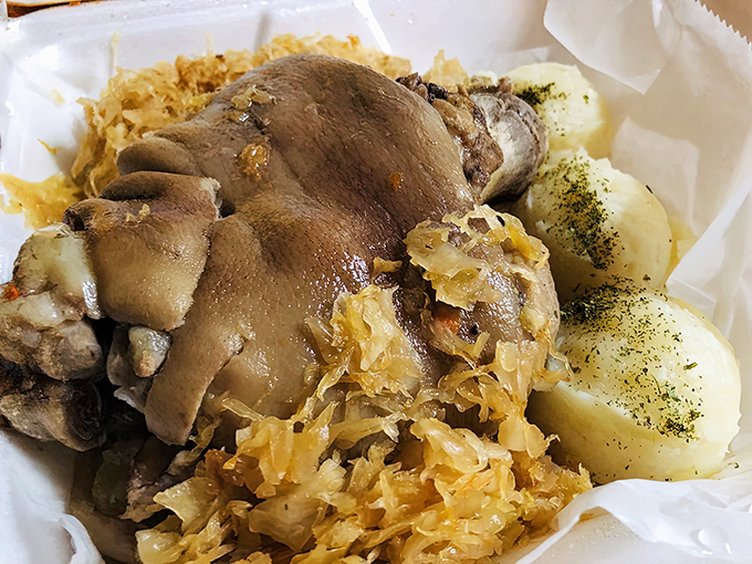 A Polish feast fit for royalty &ndash; tender pork knuckle nestled among sauerkraut and potatoes, proving that humble ingredients make extraordinary meals. 