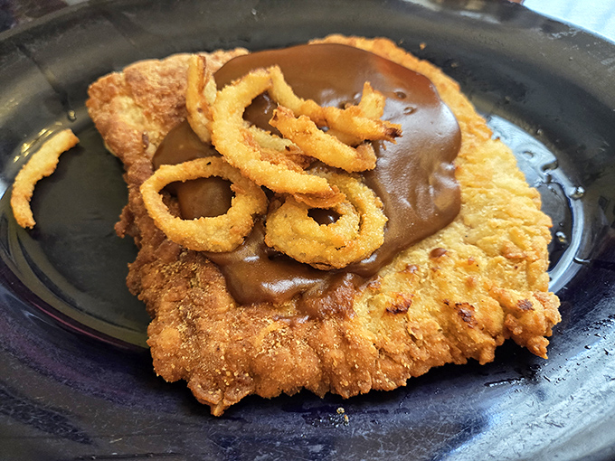 This isn't just a pork tenderloin&mdash;it's an Indiana tradition elevated with savory gravy and crispy onion rings. Comfort food that spans generations.