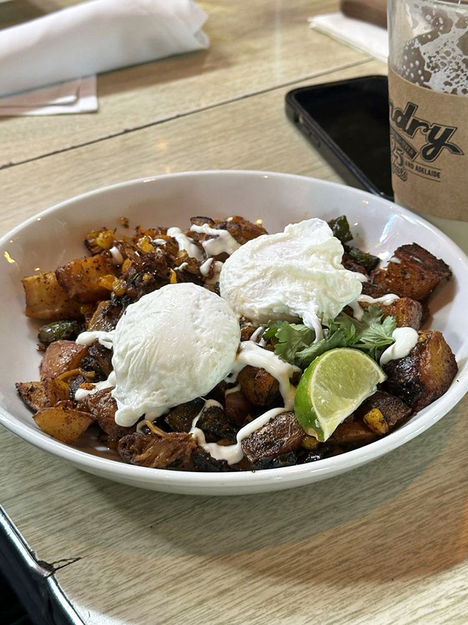 Breakfast reimagined: crispy potatoes, perfectly poached eggs, and a drizzle that ties it all together. Morning glory on a plate.