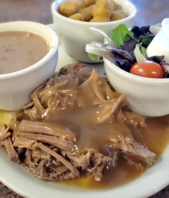 Sunday's special: fork-tender pot roast swimming in rich gravy. Grandma would approve, then ask for the recipe.