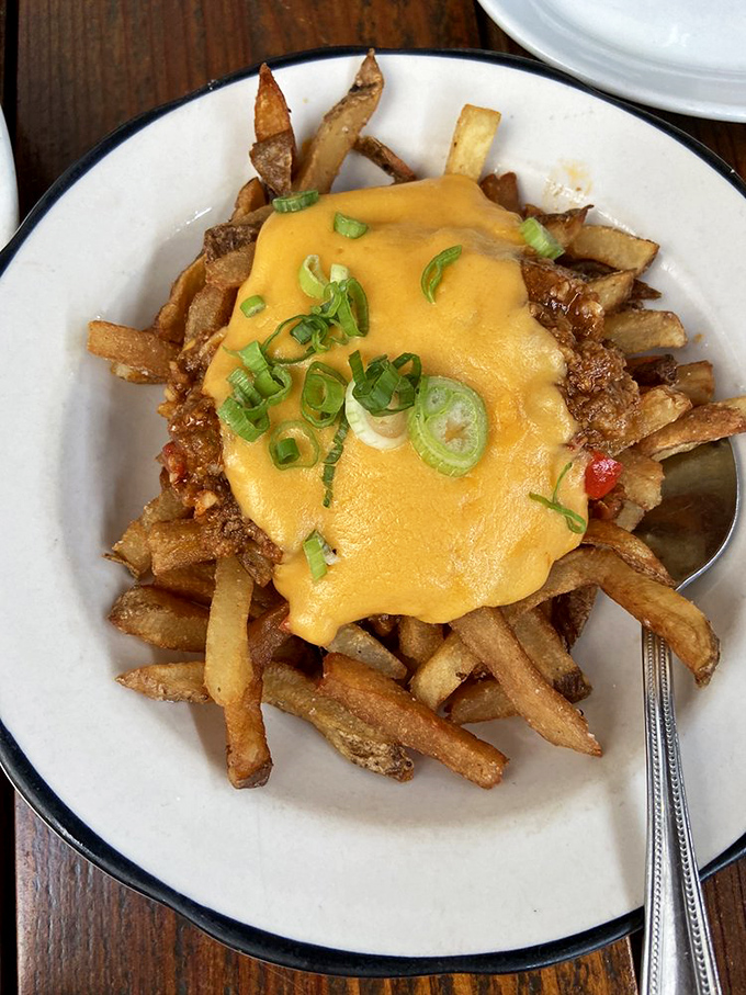 Fries smothered in melted cheese with green onions&mdash;comfort food that whispers, "Diet? What diet? We're having a moment here."