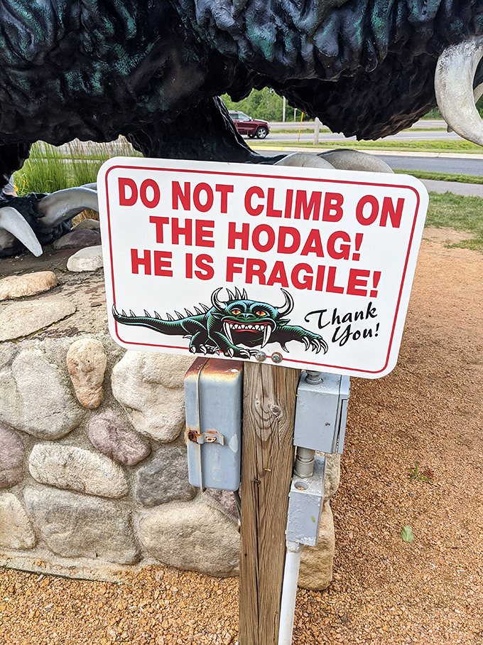 "Do Not Climb" - apparently even legendary creatures have their limits when it comes to enthusiastic visitors.