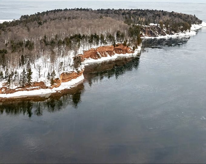 Presque Isle Park's dramatic shoreline reveals the meeting of forest and water, where ancient rock formations tell geological stories spanning millennia.