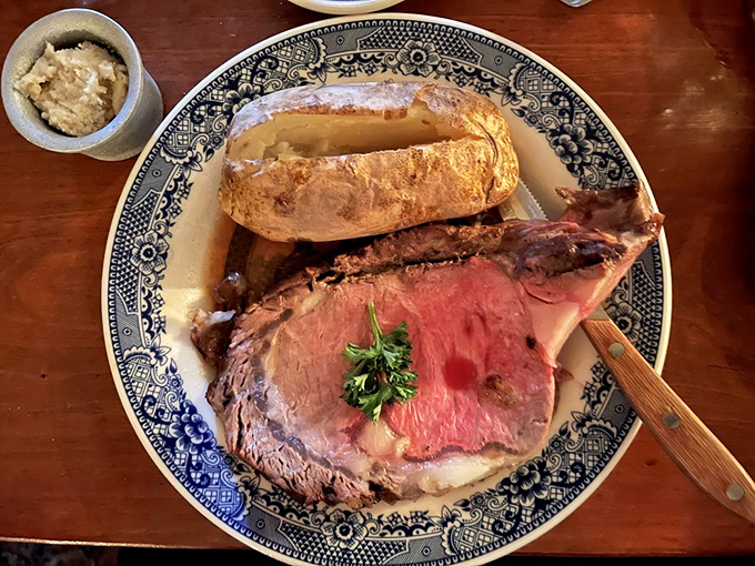 Prime rib so perfectly cooked it deserves its own historical marker. The baked potato stands guard like a delicious colonial sentry.