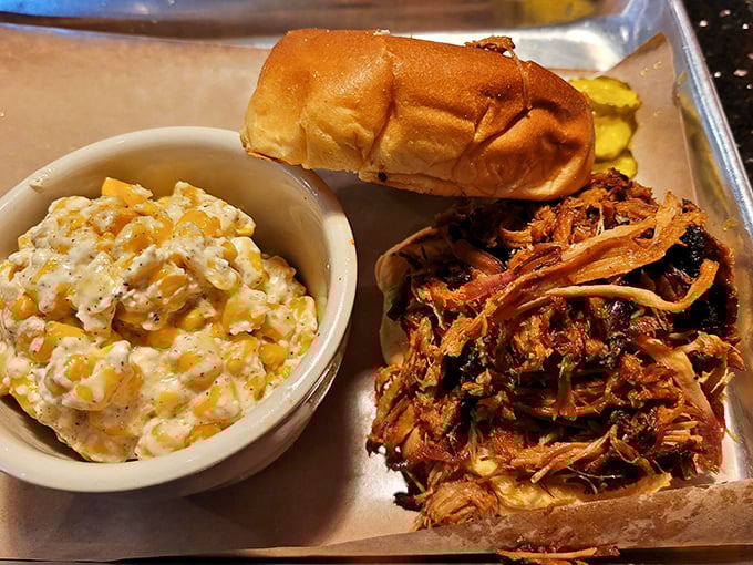 Pulled pork that surrenders at the mere suggestion of a fork, paired with creamy mac and cheese that could make a vegetarian question their life choices.