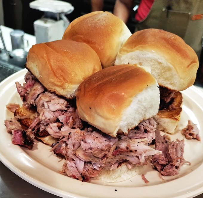 Pulled pork sliders that redefine sandwich architecture &ndash; tender meat piled impossibly high between pillowy buns. Napkins required, not optional.