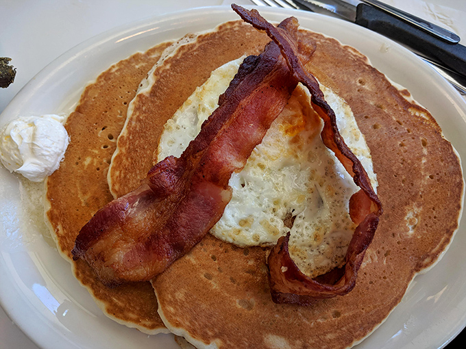 Pumpkin pancakes topped with bacon create the perfect sweet-and-savory autumn morning symphony on your plate.