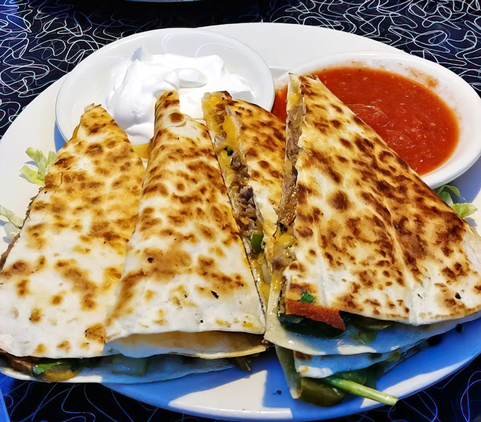 Quesadilla stacked with fillings, proving breakfast can be both art and pure indulgence.