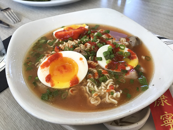 Ramen with a soft-boiled egg that's living its best life. Comfort food transcends cultural boundaries in this steaming bowl of possibility.