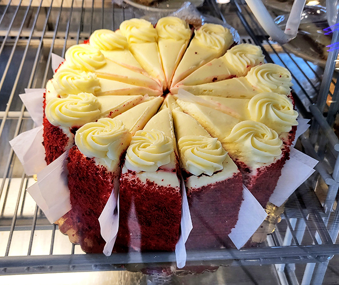 Red velvet cake sliced with mathematical precision&mdash;each piece promising the perfect frosting-to-cake ratio that dessert engineers dream about.