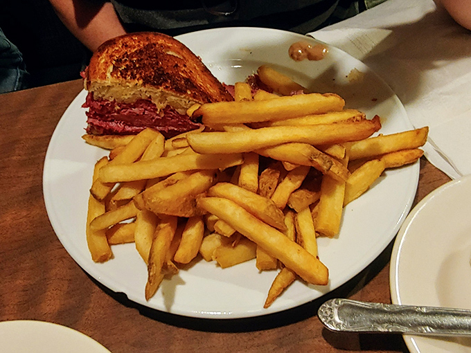 A proper Reuben should require both hands and several napkins. This beauty, with its mountain of fries, meets all sandwich requirements with flying colors.