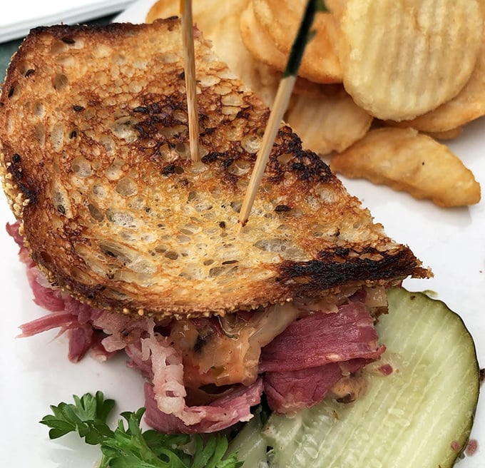 A Reuben sandwich stacked higher than your expectations, with corned beef that melts like butter.
