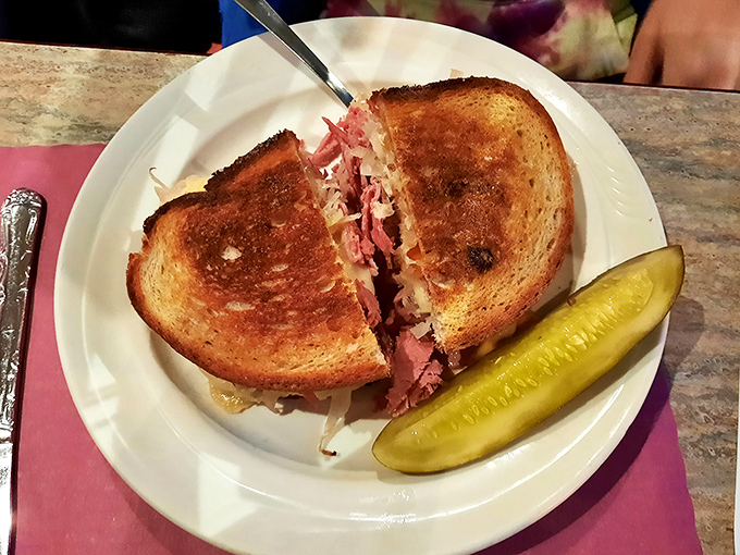 The Reuben sandwich: architectural marvel, flavor explosion, and the reason napkins were invented. Worth every delicious, messy bite.
