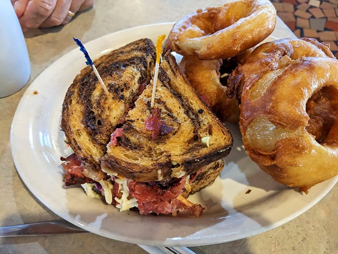 A Reuben sandwich and onion rings that would make New York delis nervous. This tower of corned beef demands a jaw unhinging worthy of a python.