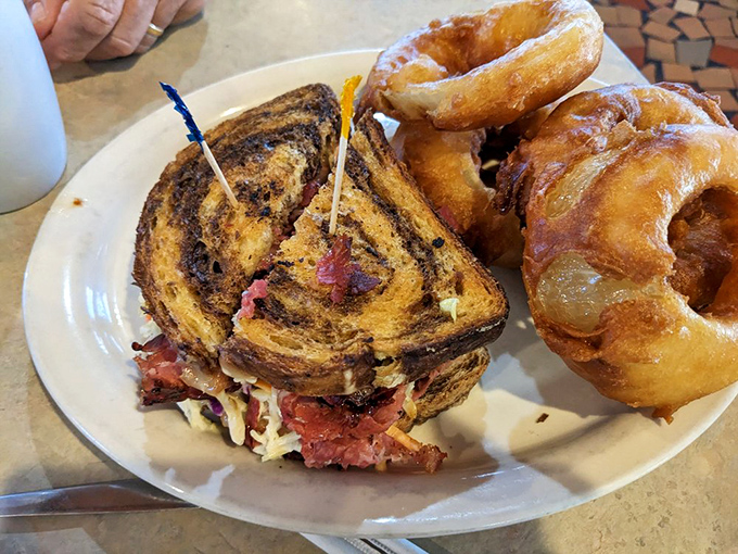 A Reuben sandwich and onion rings that would make New York delis nervous. This tower of corned beef demands a jaw unhinging worthy of a python.
