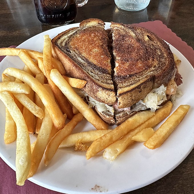 A Reuben sandwich that's more stacked than a retirement portfolio. Those golden fries are the supporting actors who steal the show.