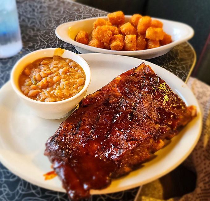 Ribs so tender they practically surrender to your fork, accompanied by baked beans and tater tots. The holy trinity of comfort.